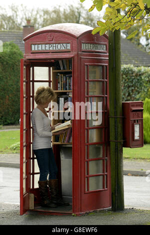 Wendy Hanlon looks at books in a red phone box which has been converted ...