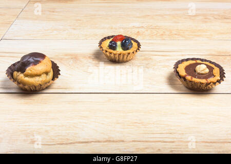 Pictured pastries on light wood background,above view with copy space ...