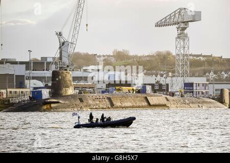 Police patrol around HMS Vanguard, one of the UK's nuclear deterrent V ...