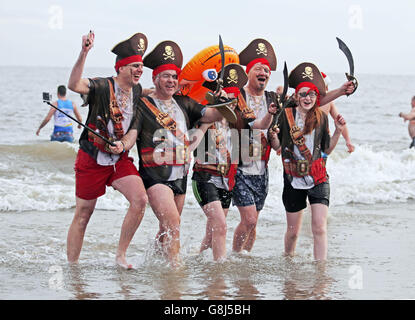 People take part in a New Year's Day Dip at Castlerock Beach in ...