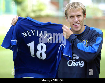 Everton's new signing Phil Neville poses for photographers following a ...