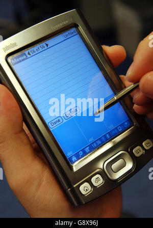 A member of the public uses a Palm Handheld PDA computer Stock Photo ...