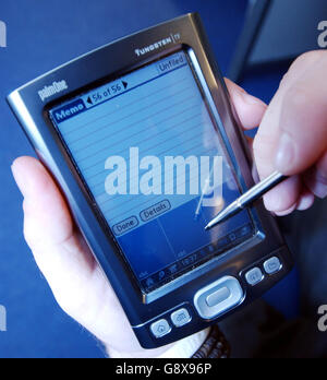 A member of the public uses a Palm Handheld PDA computer. Palmtop ...