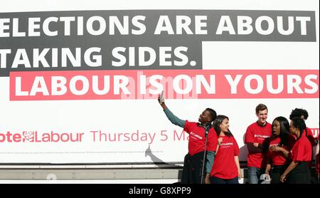 Labour supporters stand by their party's new poster for their election ...