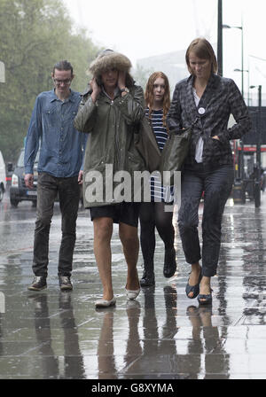 People run from the rain in east London after thunder storms hit the ...