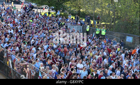Fans line the street as the Burnley parade buses pass through the town ...