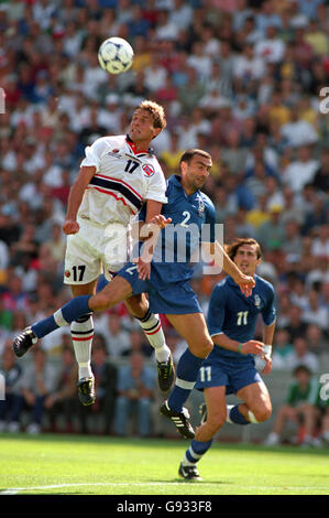 Italy's Giuseppe Bergomi (left) and Norway's Havard Flo (right) battle ...