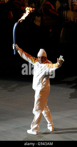 Italian Olympic legend Alberto Tomba carries the torch into Olympic ...
