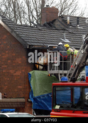 Emergency service personnel at the house Friday March 10, 2006, in ...