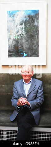 Irish playwrite Brian Friel sits beneath a portrait of himself painted ...