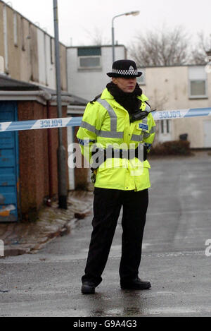 A policewoman stands guard on Torbrex Road, Cumbernauld near Glasgow ...
