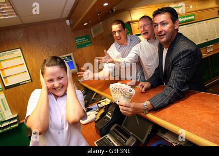 Lisa Sterio, an employee of Paddy Power Bookmakers, covers her ears ...