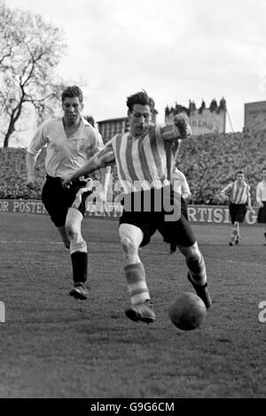 Sunderland's Len Shackleton (r) prepares to cross the ball as he is ...