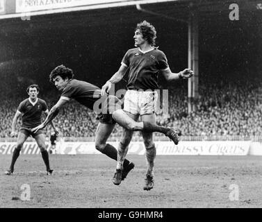 Liverpool's Kevin Keegan (l) is challenged by Everton's Mick Lyons (r ...