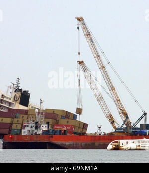 Containers are lifted off a container ship by quay cranes, at the Port ...