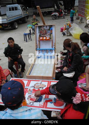 Temple scene in Luang Prabang, Laos, with monks and visitors captured ...