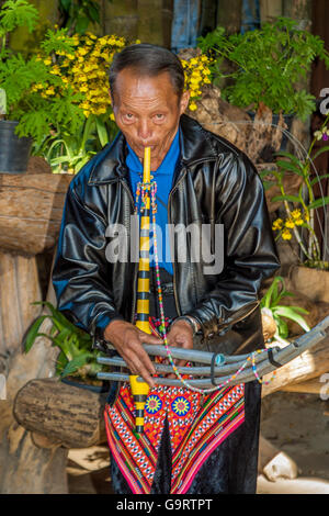 A Hmong hill tribe man playing top spinning competition (traditional ...