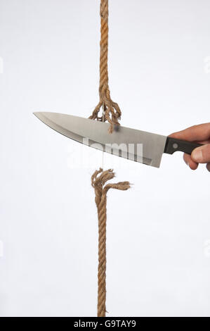 cutting a rope with a knife Stock Photo - Alamy