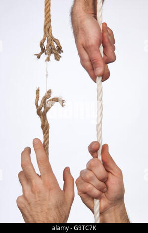 Cut and frayed rope hanging by a thread and ready to break Stock Photo ...