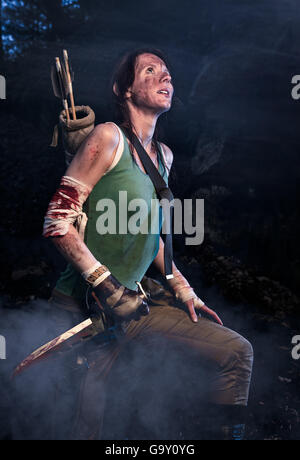 Rise of the Tomb Raider. Woman dressed up as Lara Croft aiming with a ...