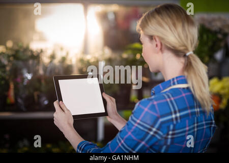 Female florist holding digital tablet Stock Photo - Alamy