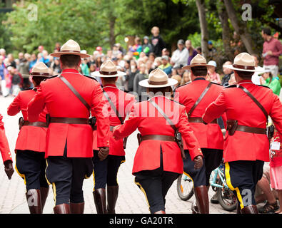 A Troop of RCMP Police officers in traditional red serge march in the ...