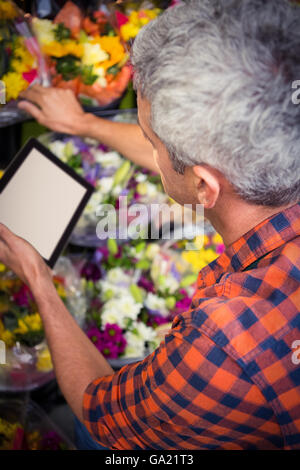 Male florist using digital tablet Stock Photo - Alamy