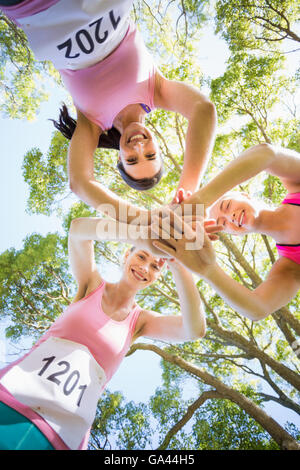 Young athlete women forming hands stack Stock Photo - Alamy