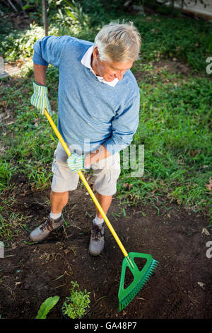 high angle view of happy senior man with beard holding vintage camera ...