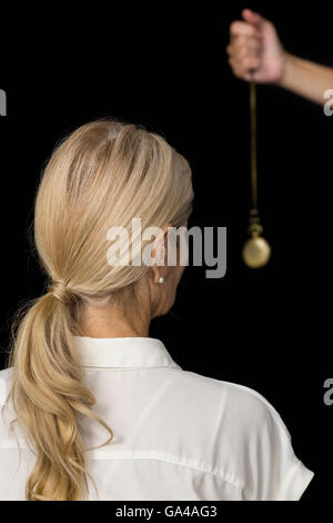 Hypnotist hypnotizing a female patient, The hand in catalepsy indicates ...