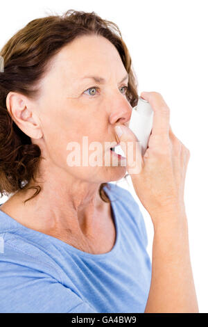 Elderly woman with asthma using inhaler to alleviate symptoms, Reading ...