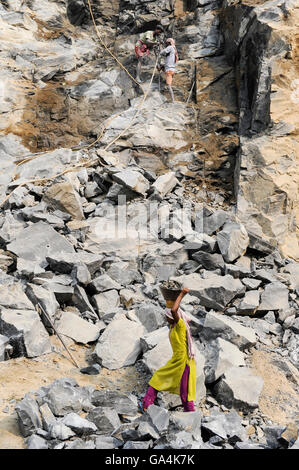 Women hard labor work danger job crush rock poverty Stock Photo - Alamy