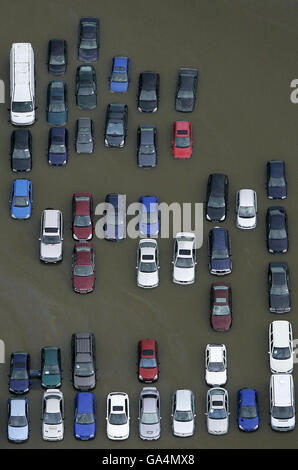 Cars are half-submerged in the flooded area caused by heavy rain in ...