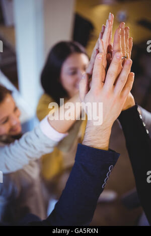Hispanic business people high-fiving Stock Photo - Alamy
