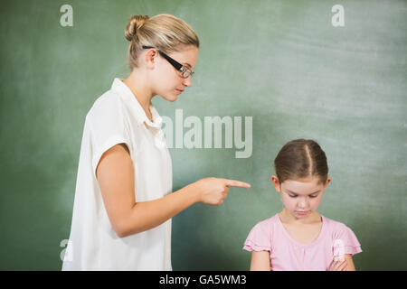 Angry Teacher Pointing At Schoolboy In Classroom Stock Photo - Alamy
