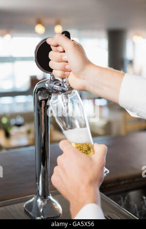 Waiter filling beer from bar pump Stock Photo - Alamy
