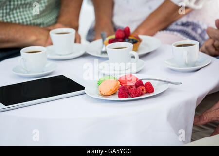 Cropped image of friends sitting on the floor and playing cards Stock ...