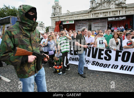 A Republican dressed as a Loyalist terrorist takes part in a Republican ...