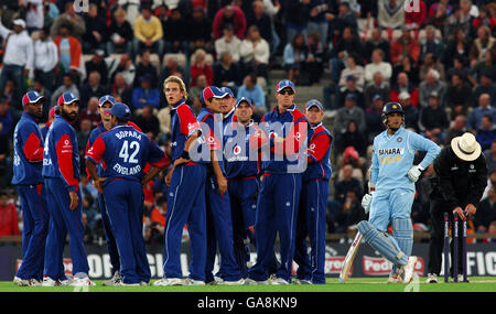 England players await third umpire's decision for the wicket of India's ...