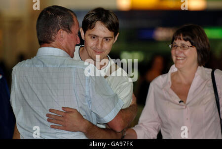 Briton Jody Aggett (centre) is greeted by parents Tony and Lorna, son ...