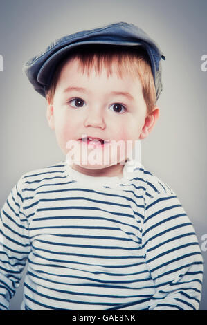 Young boy wearing his cap looks cool in a studio pose Stock Photo - Alamy