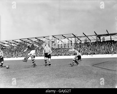 West Ham United's Ted Fenton (r) is nudged off the ball by Brentford's ...