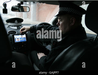 A Strathclyde Police officer using a new integrated computer system ...