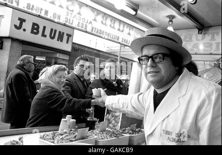 The Reverend John Pellow, a Congregational minister, handing out free ...