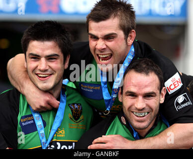 Northampton Saints players celebrate with the trophy on the pitch after ...
