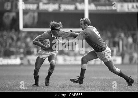 (L-R) President's XV's Roger Gould is tackled by Wales' Richard ...