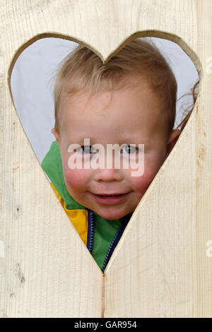 Portrait of little boy looking through binoculars on river bank. Cute ...