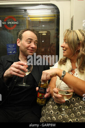 Revellers drink on a tube train, before the ban on drinking alcohol ...
