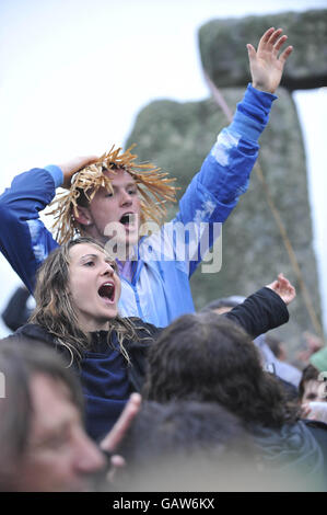 Revelers chant in the early morning drizzle as bad weather and rain ...