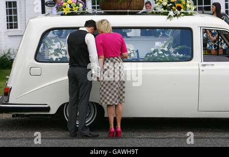 Sally Knox comforts her son Jamie in front of the hearse carrying the ...